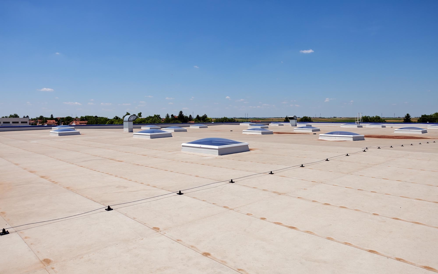 Image of a flat white commercial roof. | Parsons Commercial Roofing